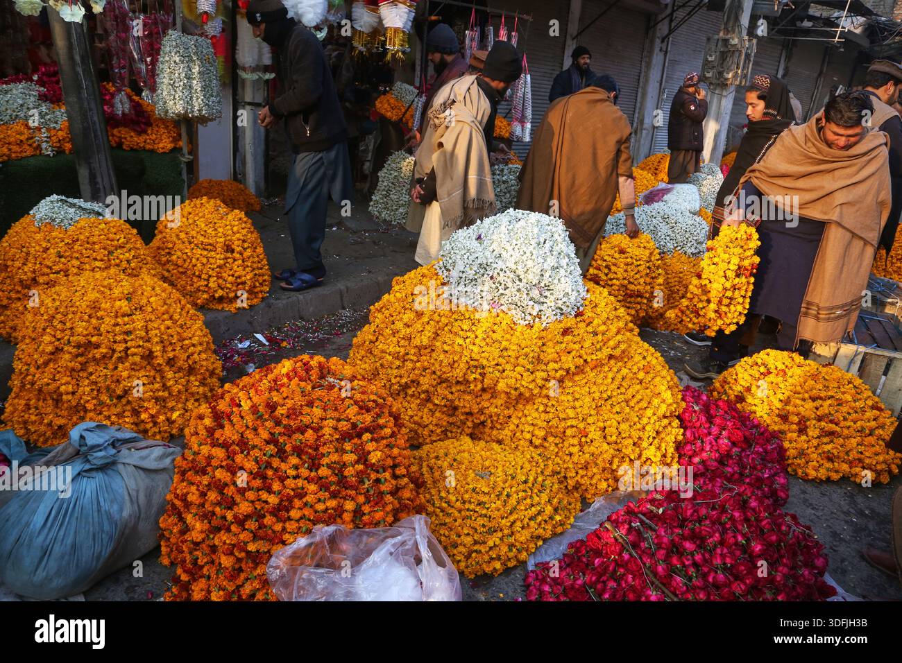 People purchase flowers at a market in Peshawar, Pakistan, Tuesday, Jan ...