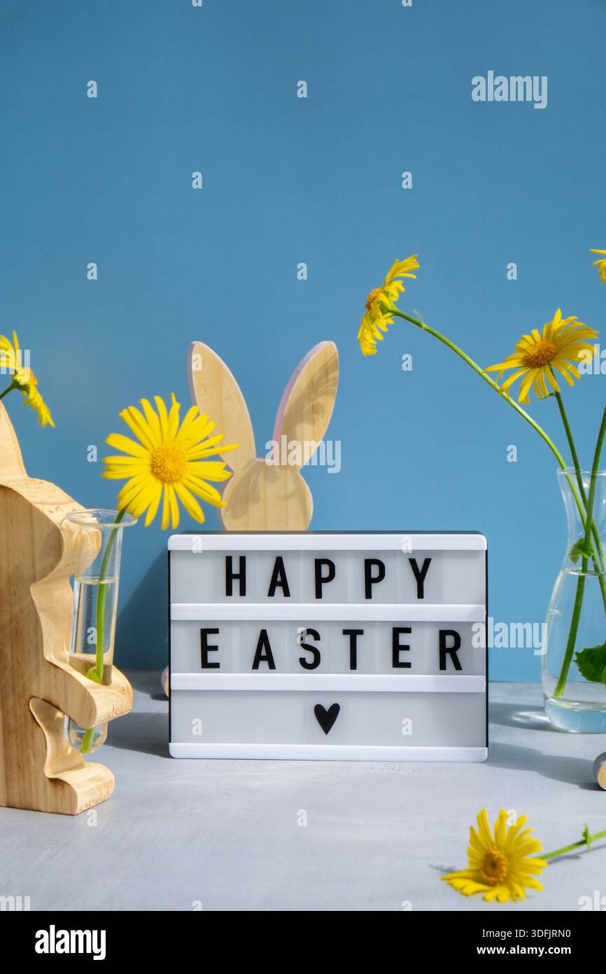 Happy Easter text on Lightbox with bunny wooden figures and fresh ...