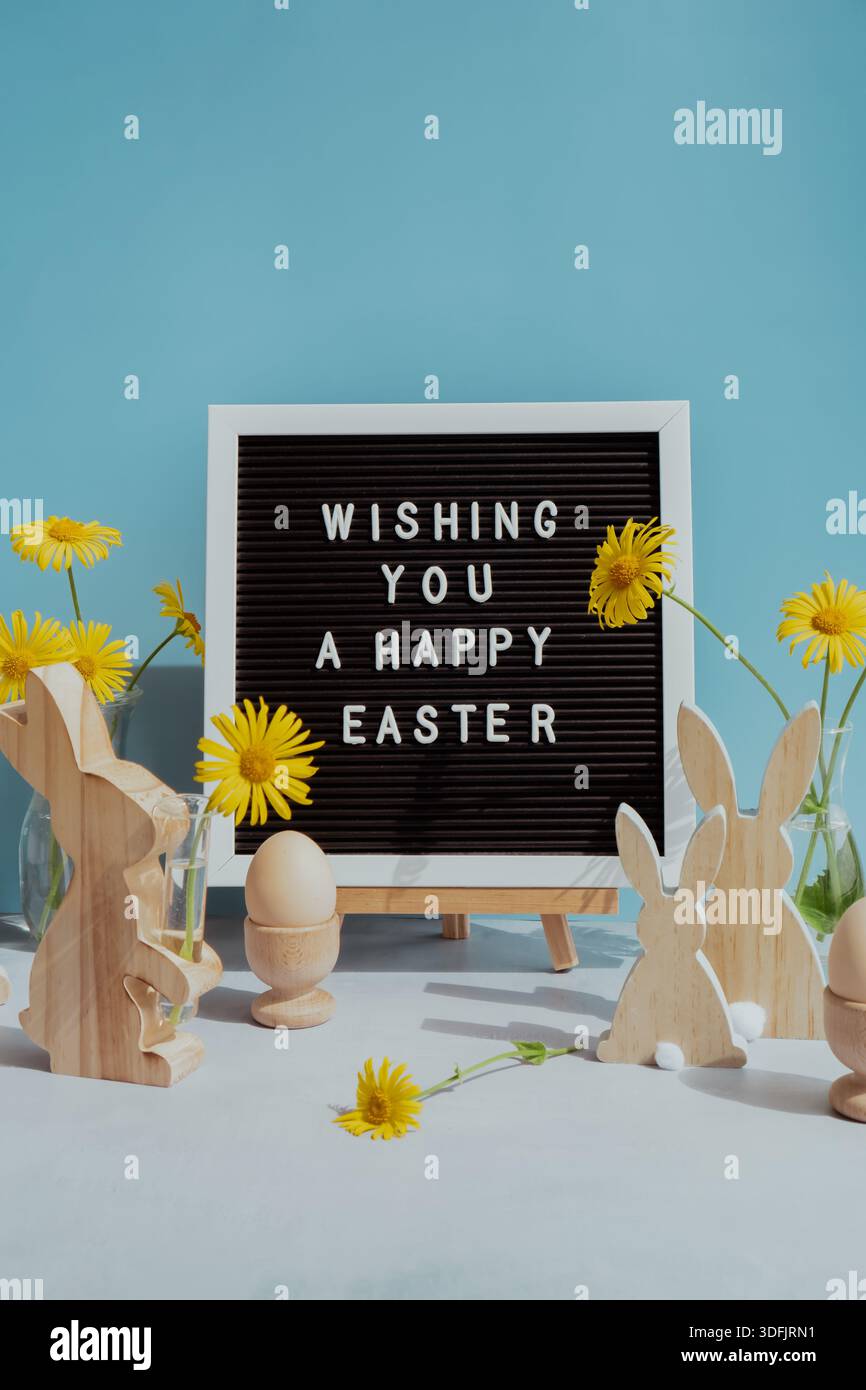 Letter board with message WISHING YOU A HAPPY EASTER on festive blue ...