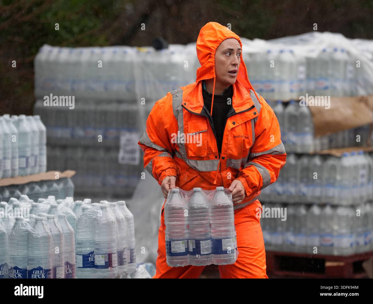 South East Water staff hand out bottled water at a water station in ...