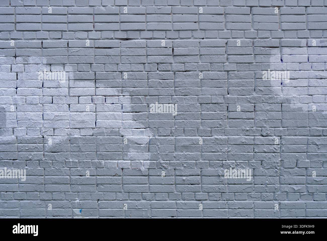 The old wall is unevenly painted. Abstract construction background ...