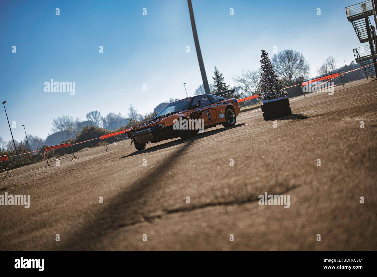 Imola, italy 01 january 2026: orange modified racing car powering a ...
