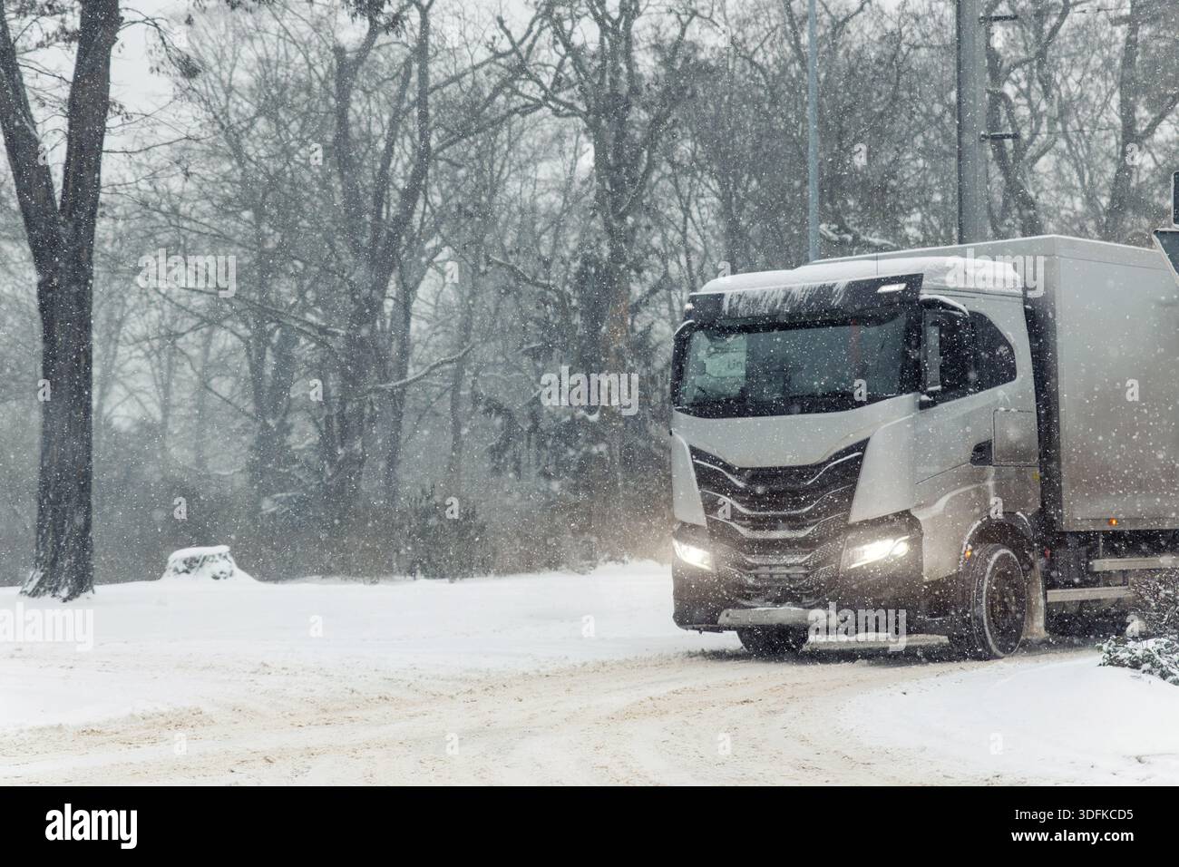 Winter logistics scene cargo truck driving heavy snowfall icy road ...