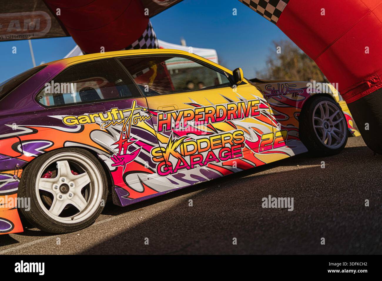 Imola, italy 01 january 2026: sports car with vibrant graffiti flame ...