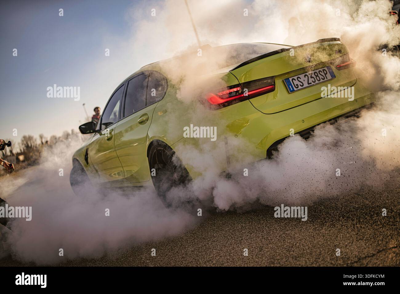 Imola, italy 01 january 2026: lime green bmw m3 emits huge white smoke ...