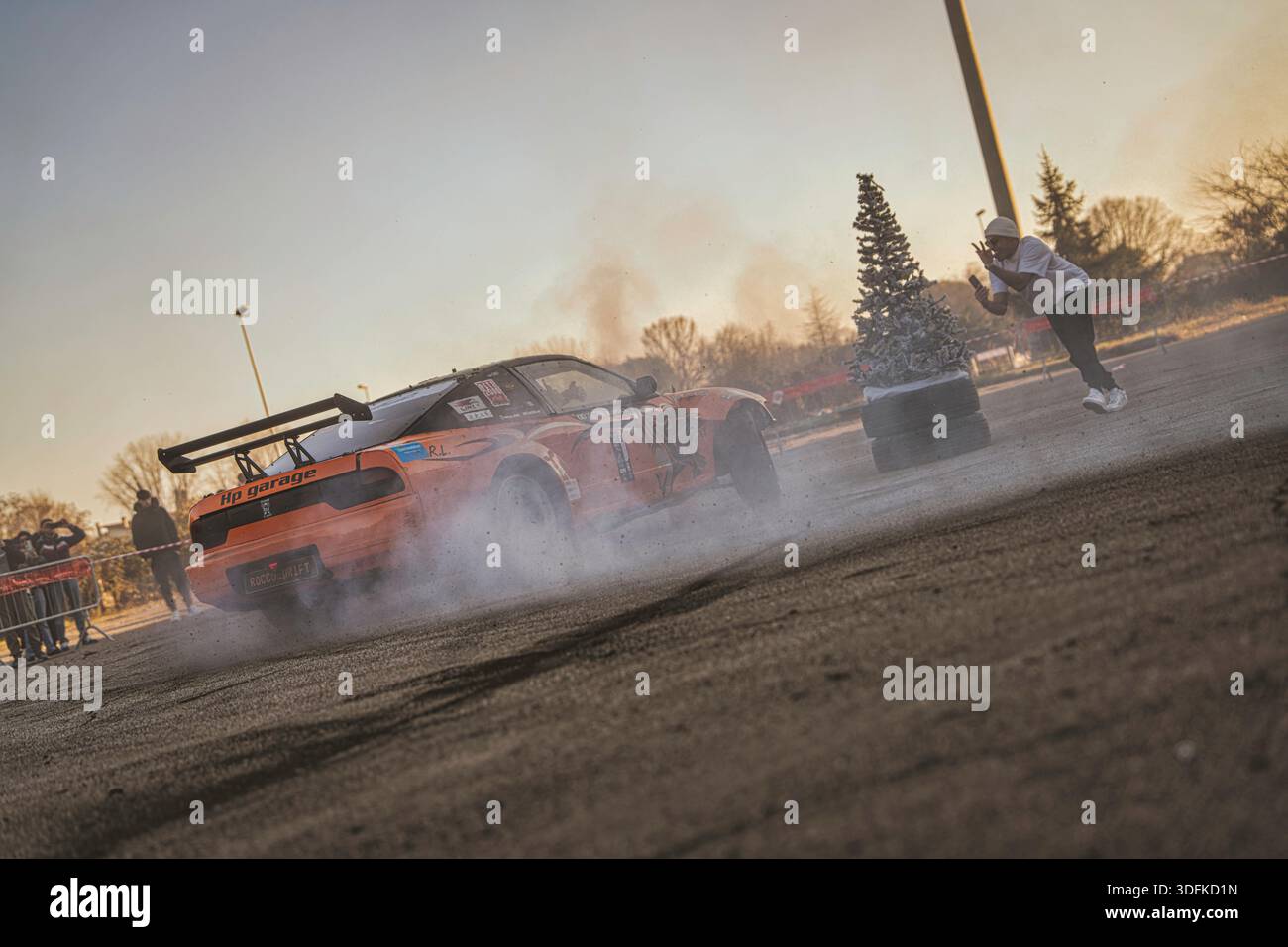 Imola, italy 01 january 2026: orange racing car performing a drift ...