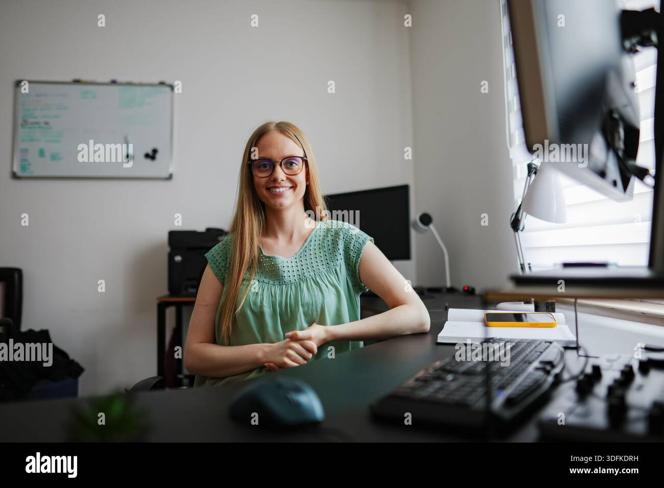 Smiling professional in a cozy office during a bright workday Stock ...
