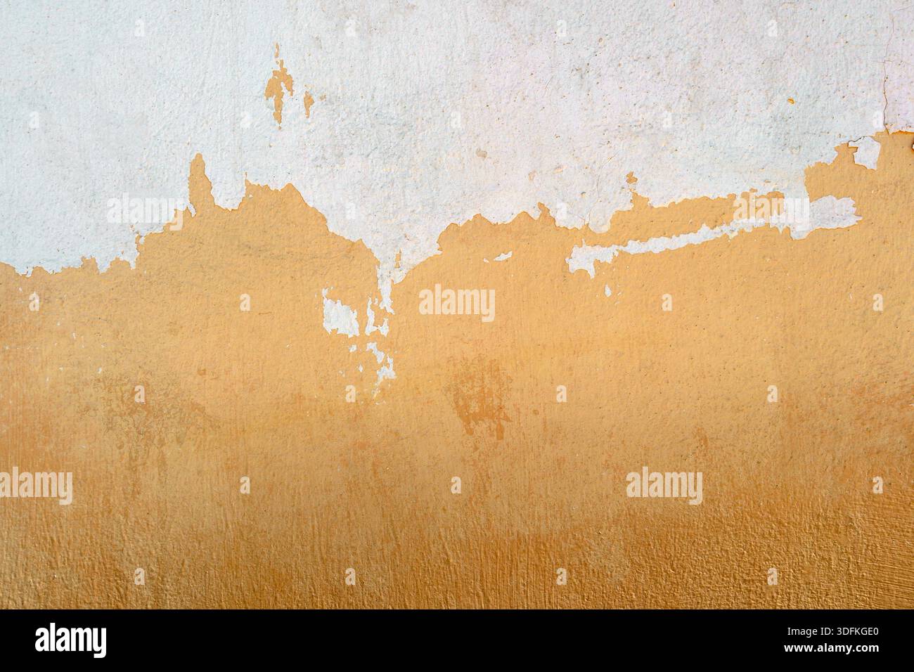 A beige wall is half painted with white paint. Abstract design ...