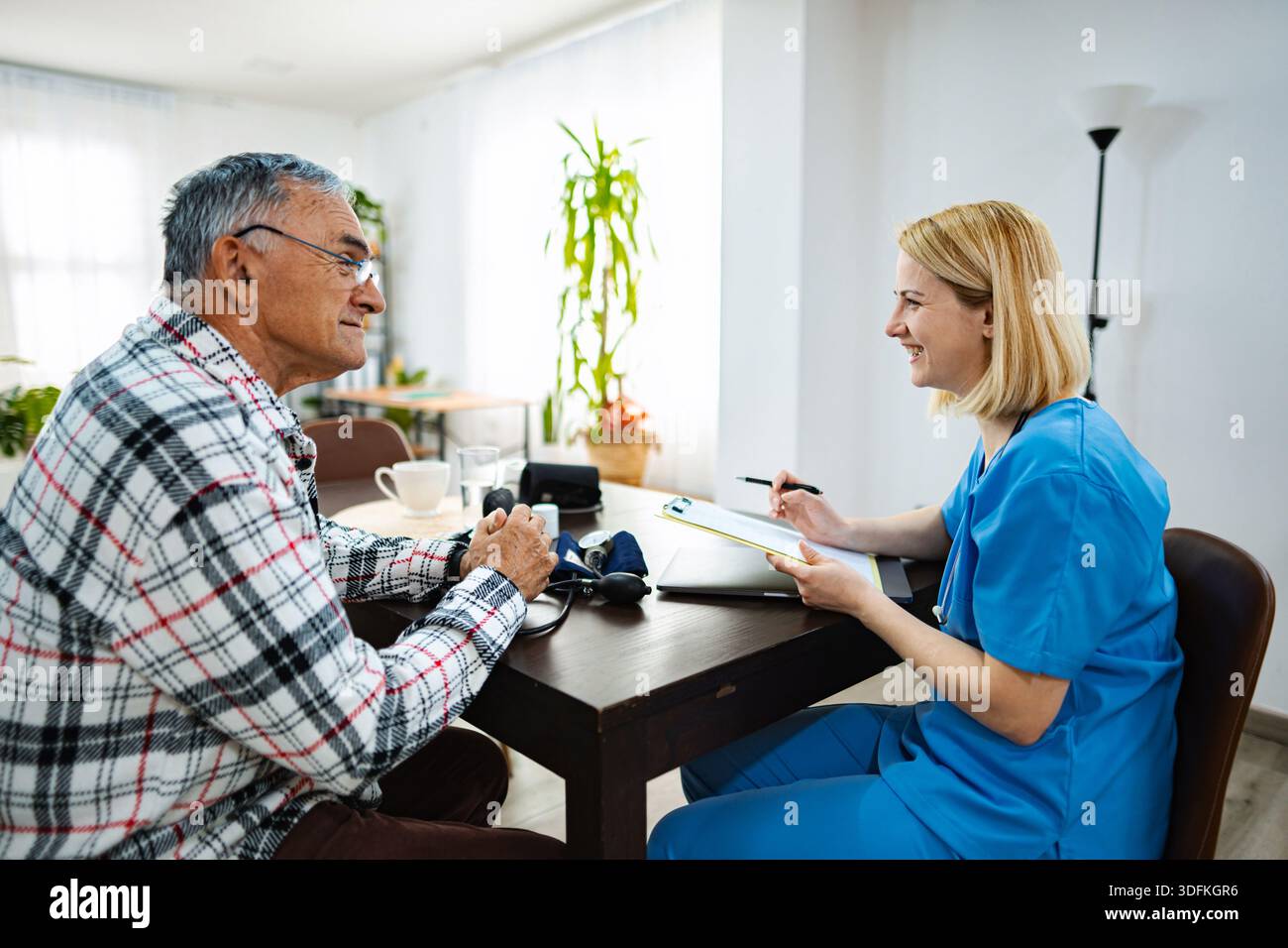 Caring conversation between nurse and patient in clinic Stock Photo - Alamy