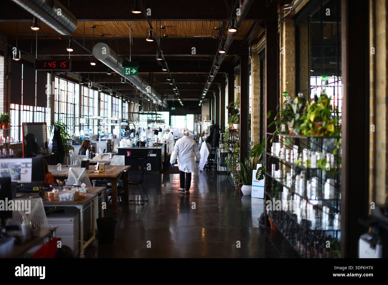 People are seen walking around the lab area of Deciem's Toronto ...