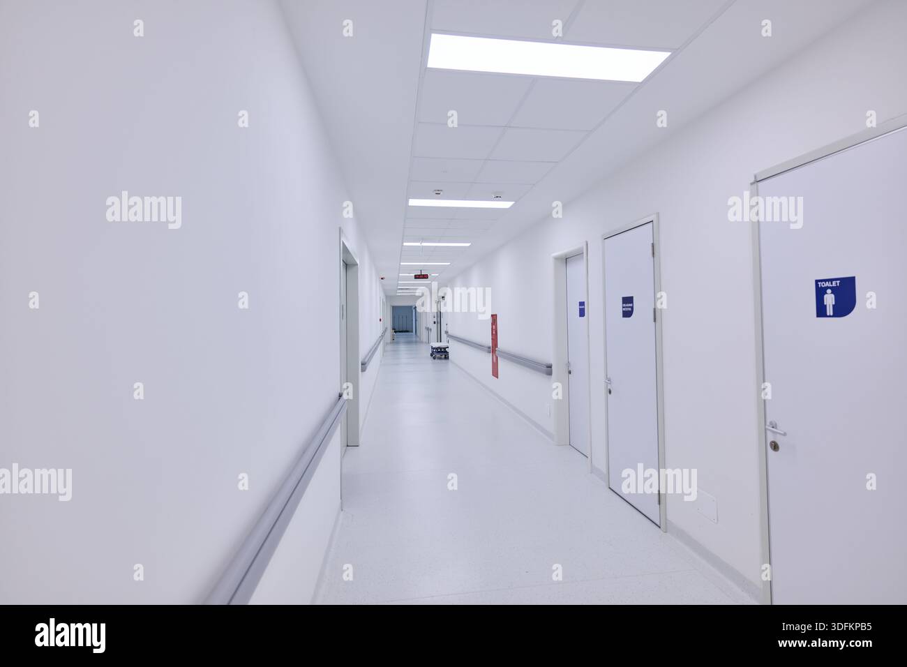 Healthcare facility hallway with clean design and accessible restrooms ...