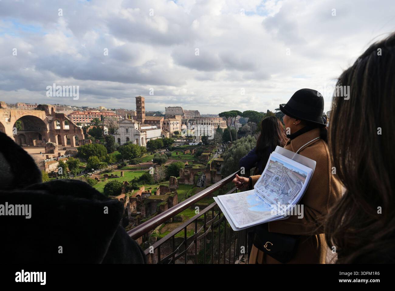A tourist guide explains the history of the Colosseum and the Roman ...