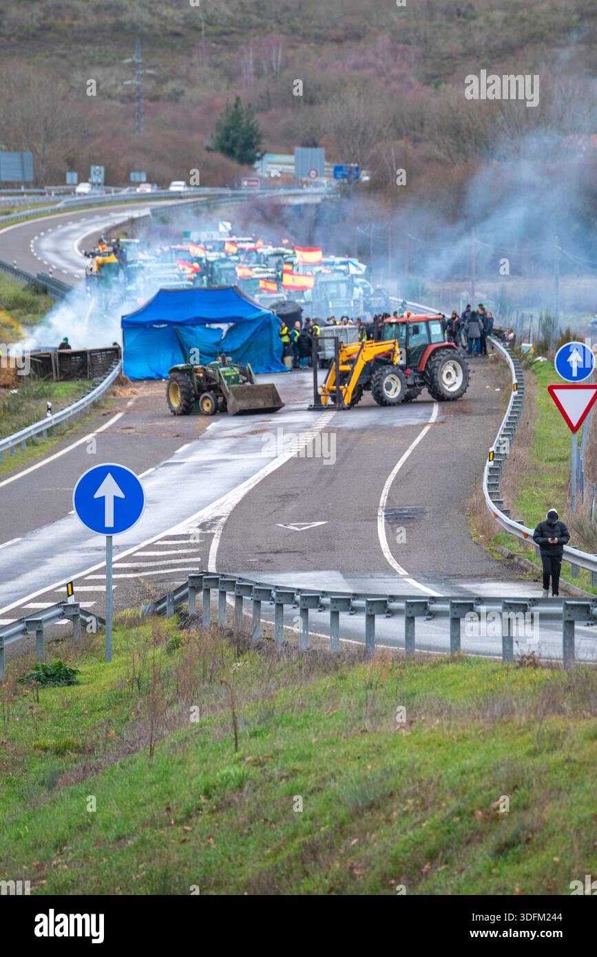 Spanish farmers on strike with flags and smoke from burning tires on ...