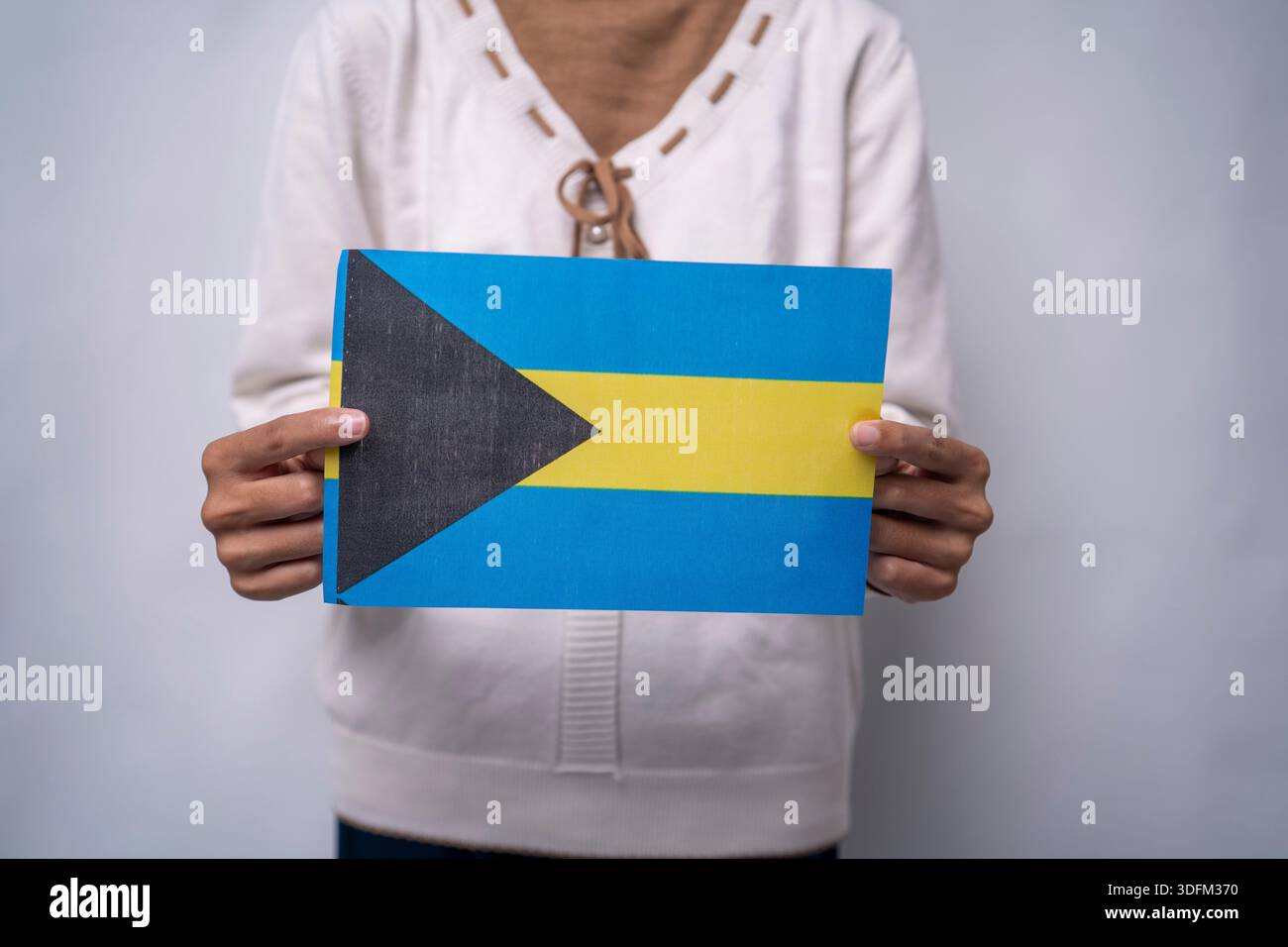 Hands Holding Flag of the Nation Bahamas Stock Photo - Alamy