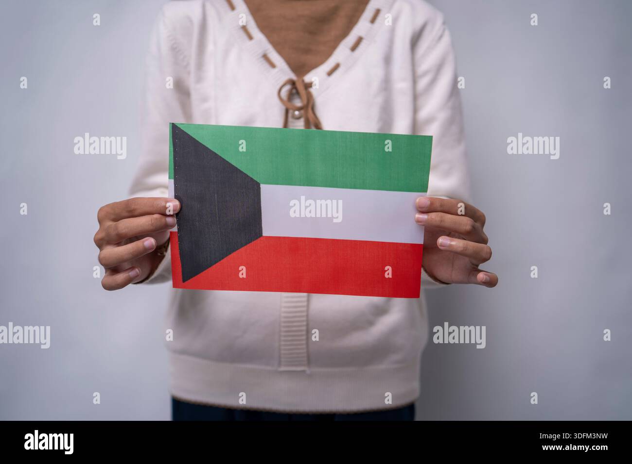 Hands Holding Flag of the Nation Kuwait Stock Photo - Alamy