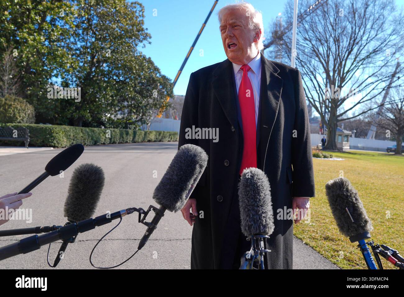 President Donald Trump speaks to reporters before boarding Marine One ...