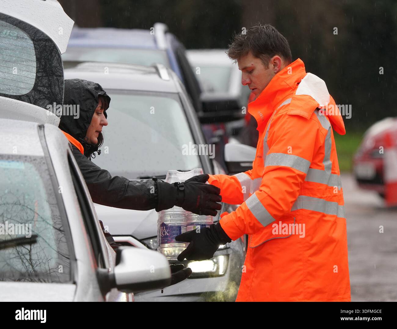 South East Water staff hand out bottled water at a water station in ...