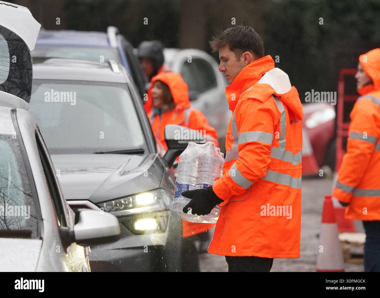 South East Water staff hand out bottled water at a water station in ...