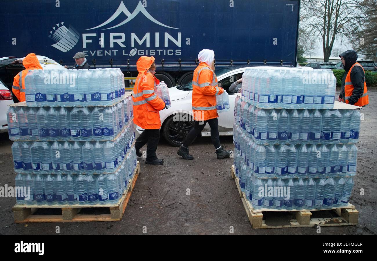 South East Water staff hand out bottled water at a water station in ...