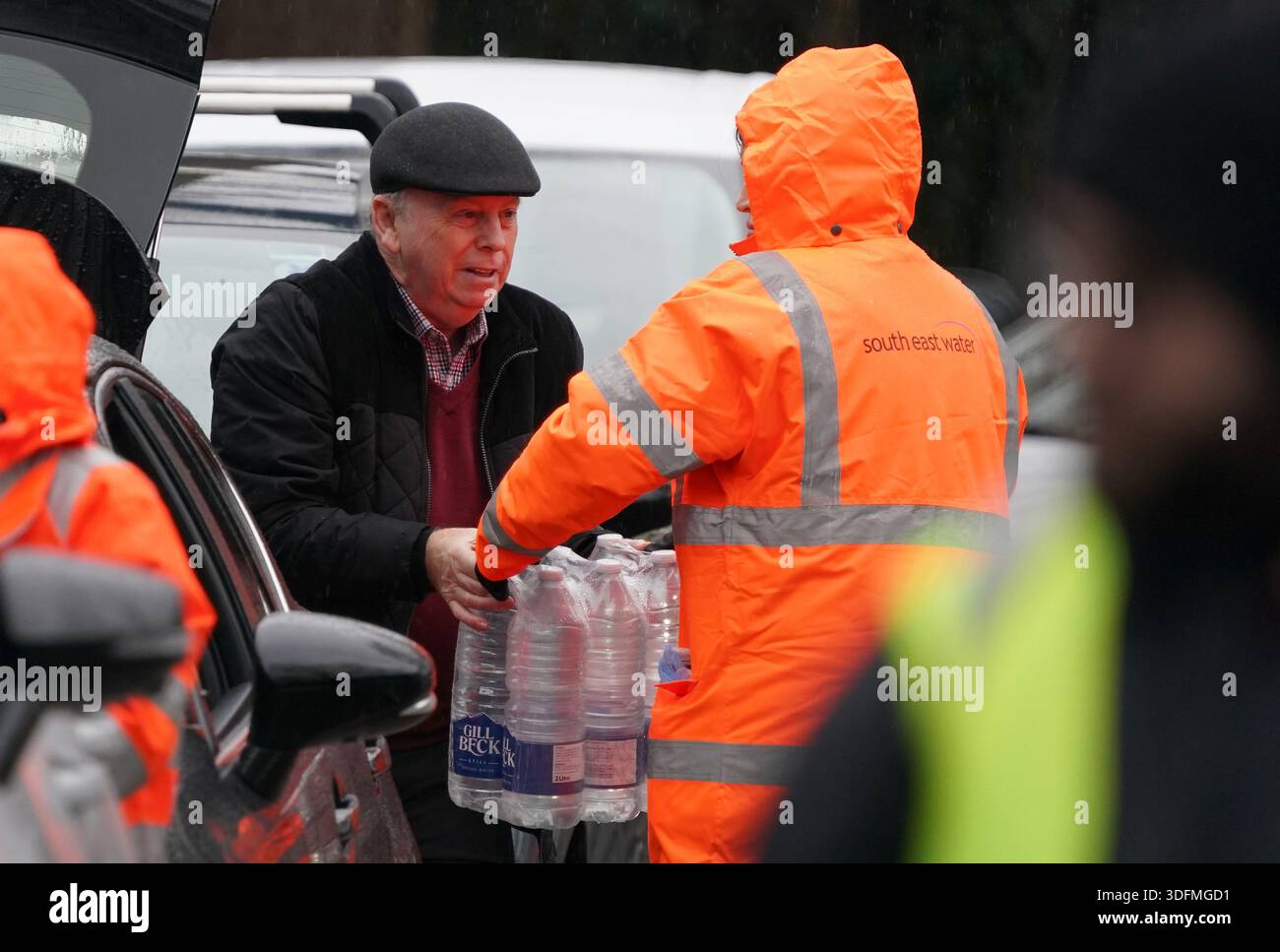 South East Water staff hand out bottled water at a water station in ...