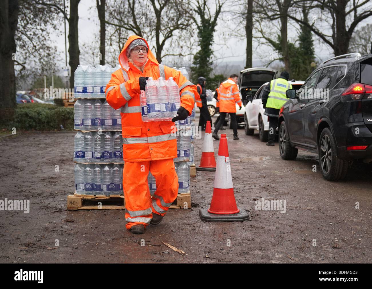 South East Water staff hand out bottled water at a water station in ...