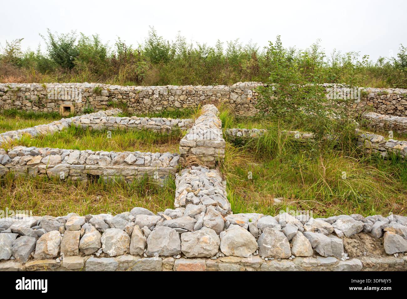 View of stone ruins and grassy patches create a textured landscape ...