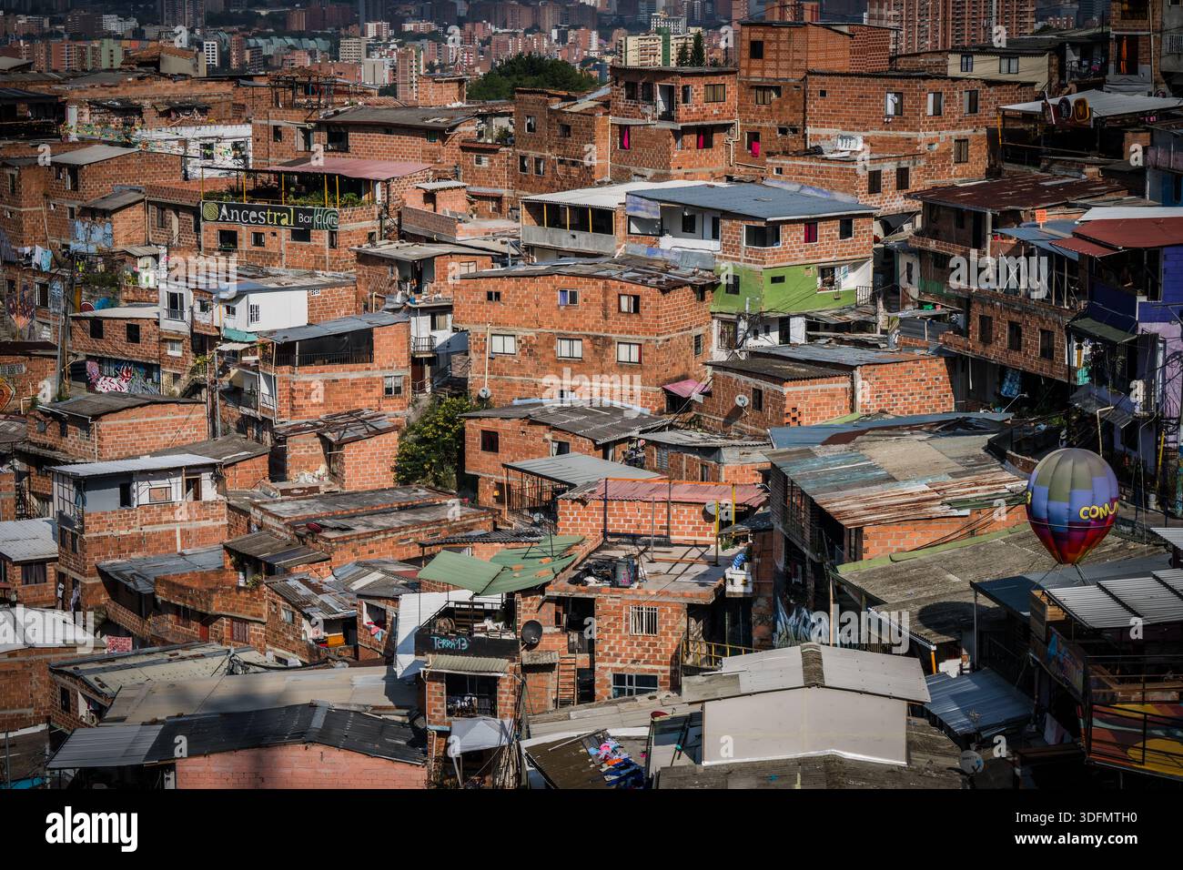 View of the dense, red-brick buildings cascade down the hillside in a ...