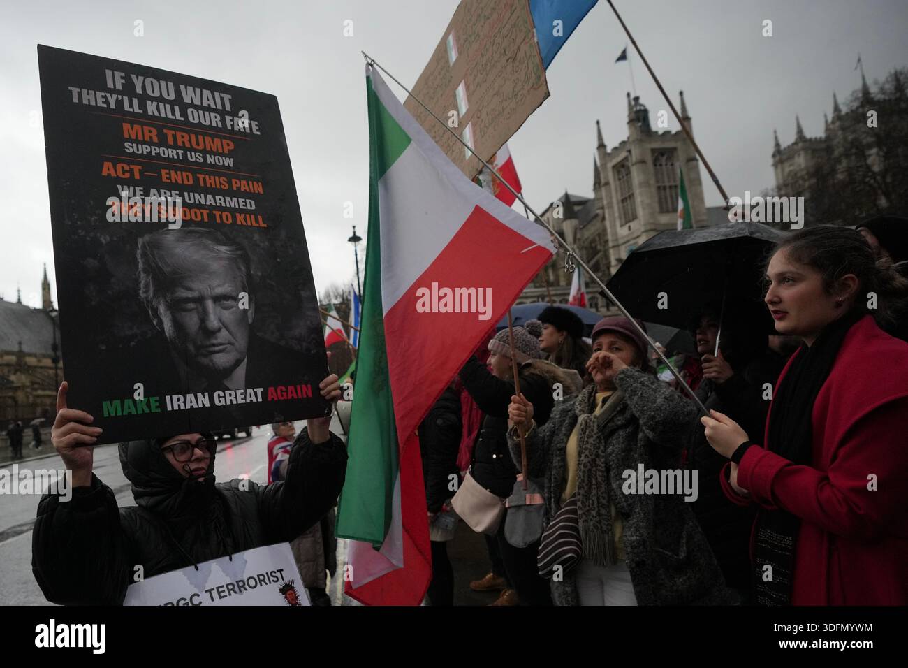 Protesters hold up placards as they demonstrate outside the House of ...