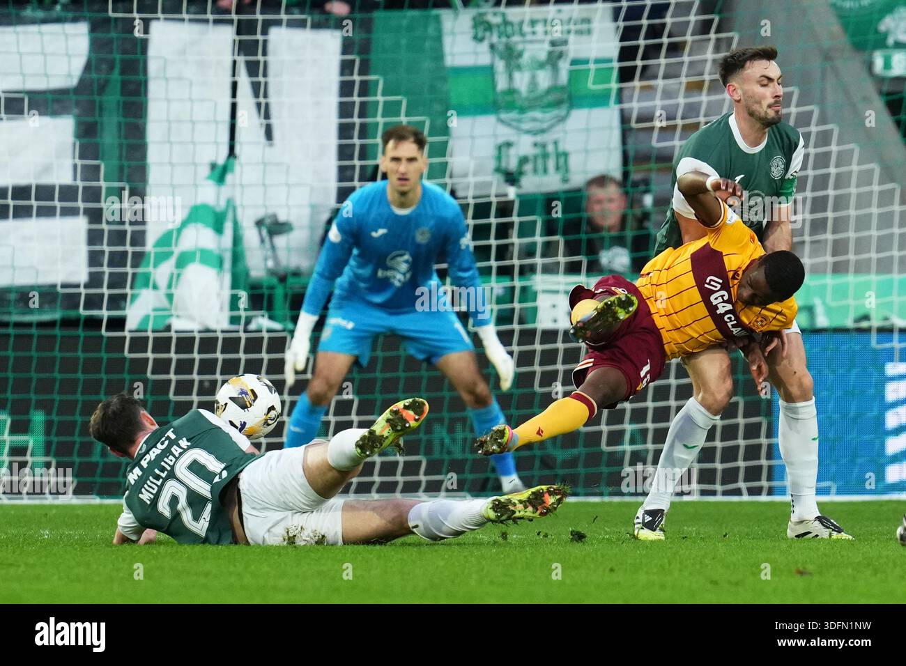 Tawanda Maswanhise of Motherwell FC and Josh Mulligan of Hibernian FC ...