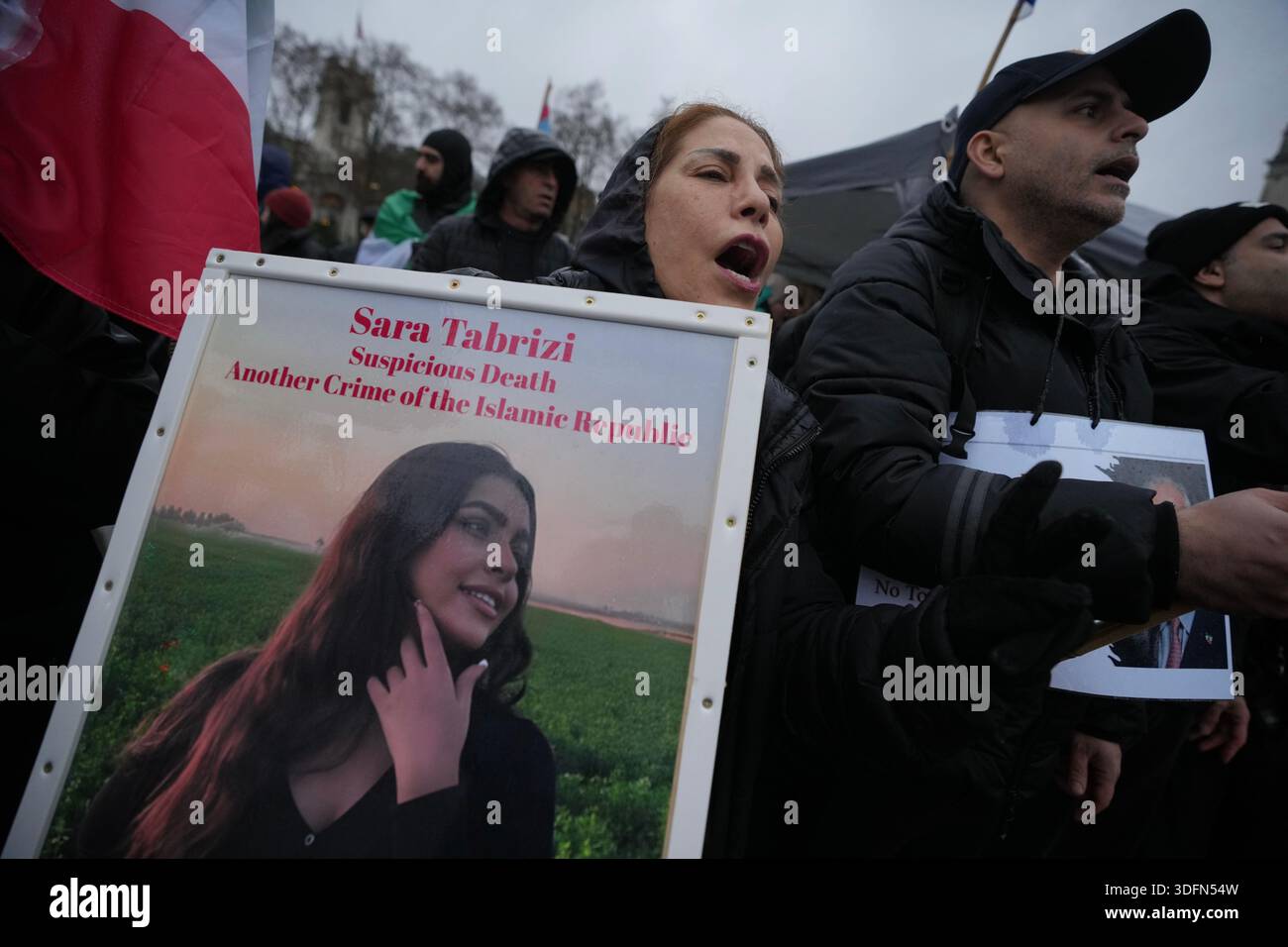 Protesters hold up placards as they demonstrate outside the House of ...