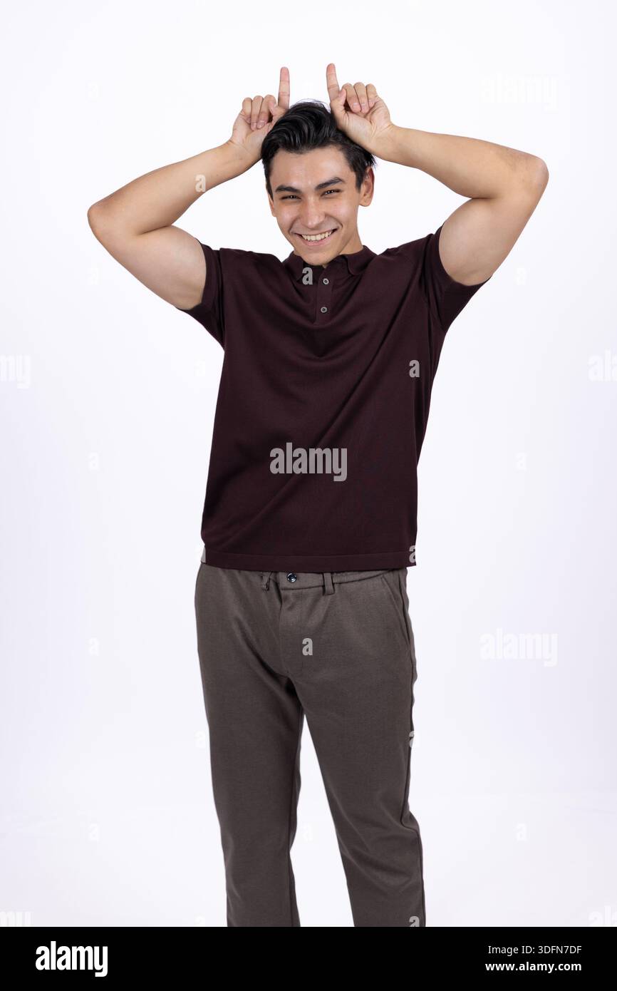 Young man making playful gesture hi-res stock photography and images ...