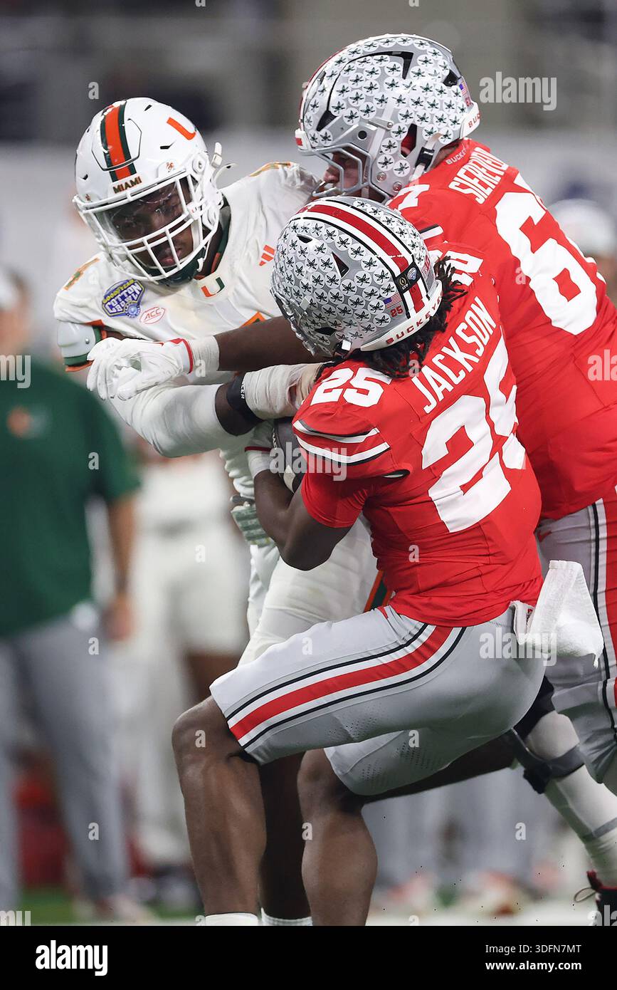 Miami defensive end Rueben Bain Jr. (4) grabs Ohio State running back ...