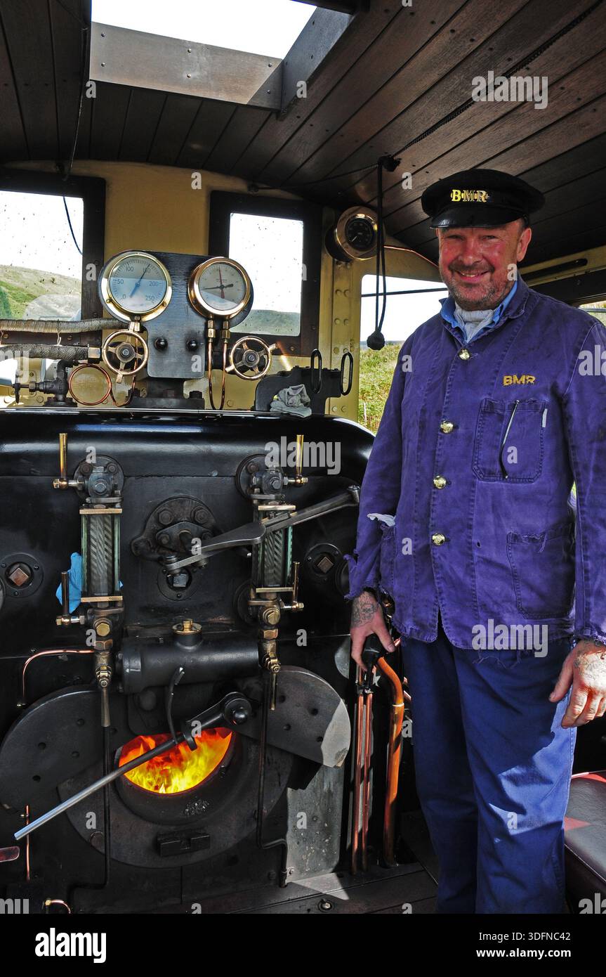 The Driver in the cab of the steam locomotive on Brecon Mountain ...