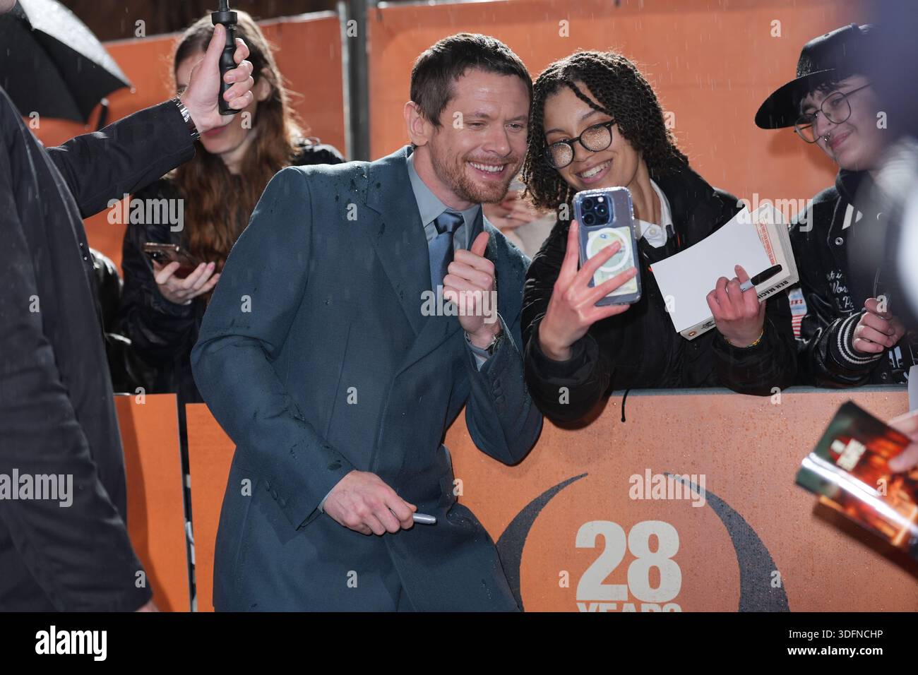 Jack O'Connell having a selfie taken while attending the world premiere ...