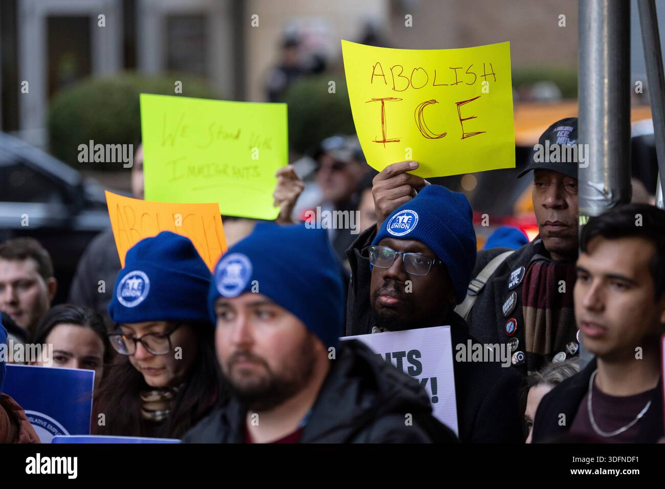 People raise signs in support of immigrants during a news conference ...