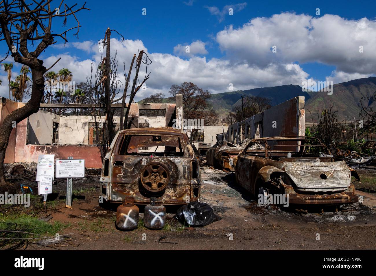 FILE - Burned cars and propane tanks with markings on them sit outside ...