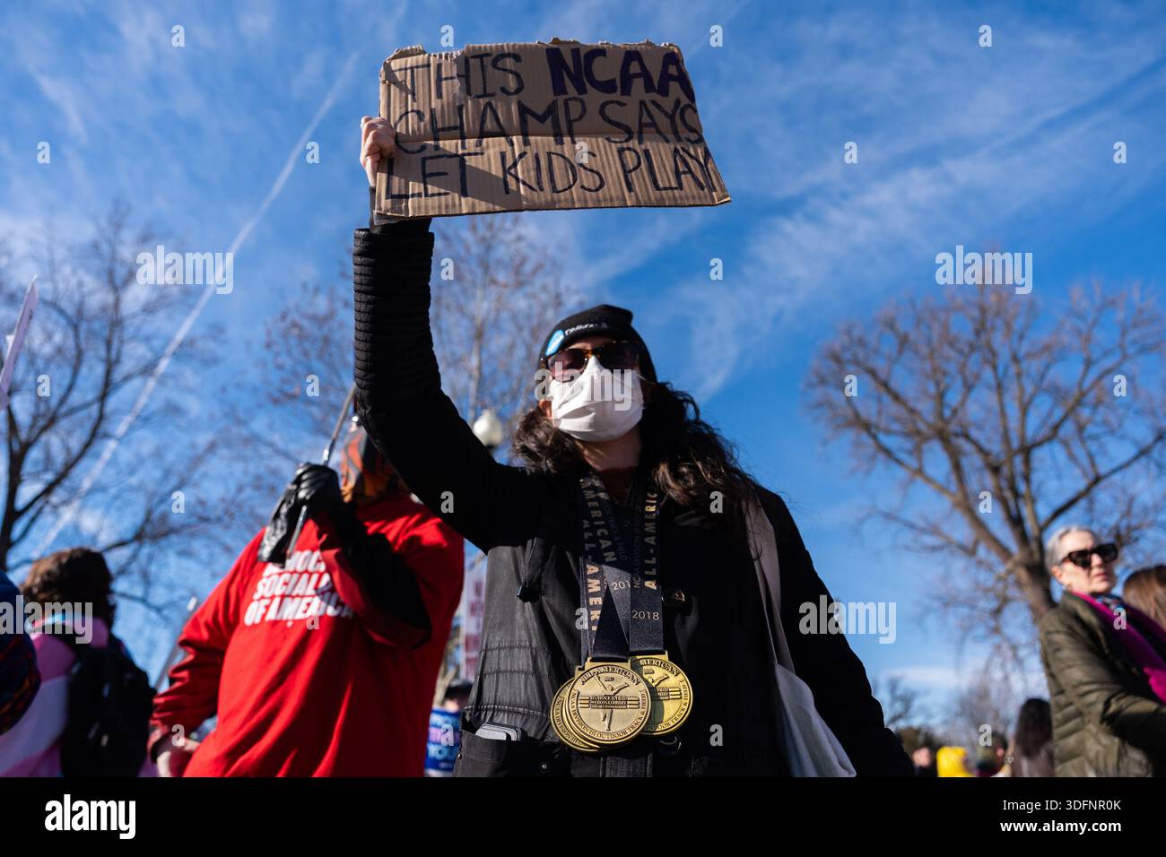 A protestor wears NCAA medals outside the Supreme Court during ...