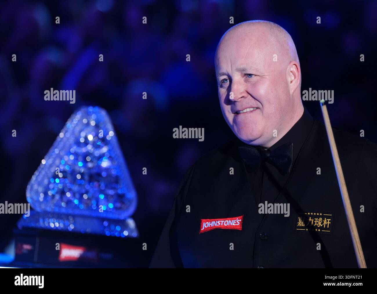 John Higgins walks out to face Barry Hawkins (out of picture) on day ...