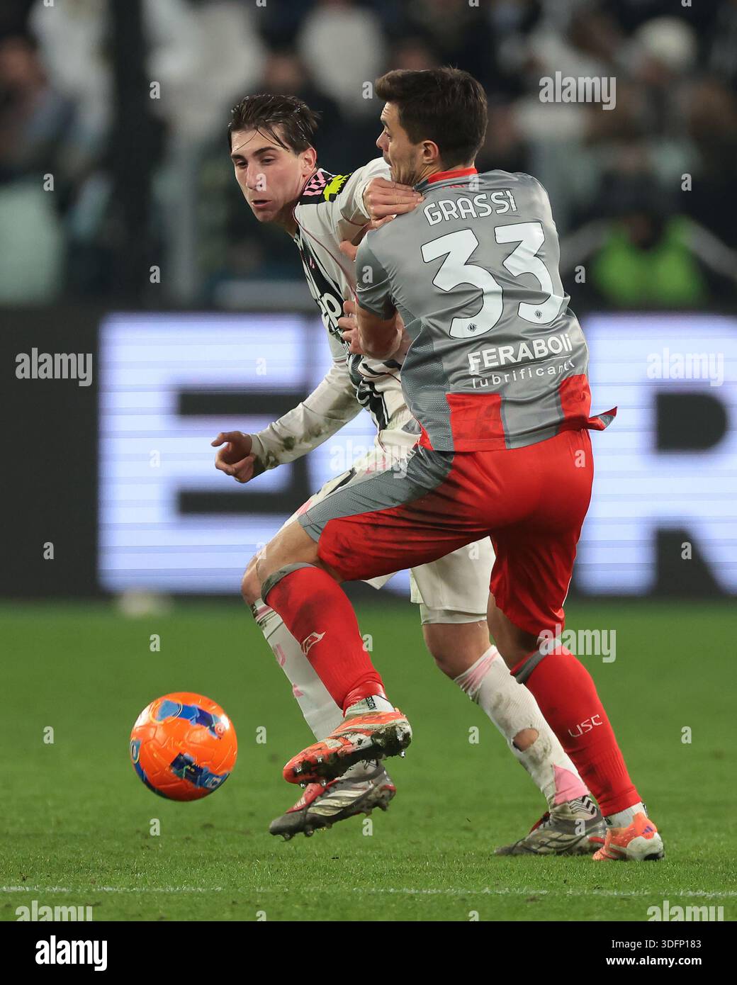 Turin, Italy, 12th January 2026. Fabio Miretti of Juventus tussles ...