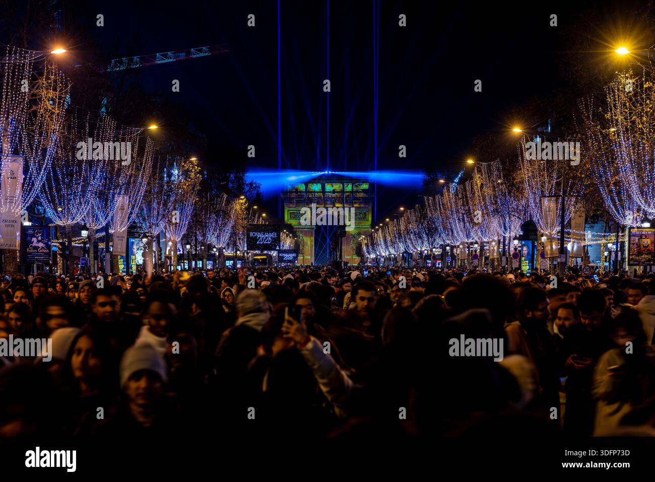 Paris, France - January 1, 2026: The crowd gathered on the Champs ...