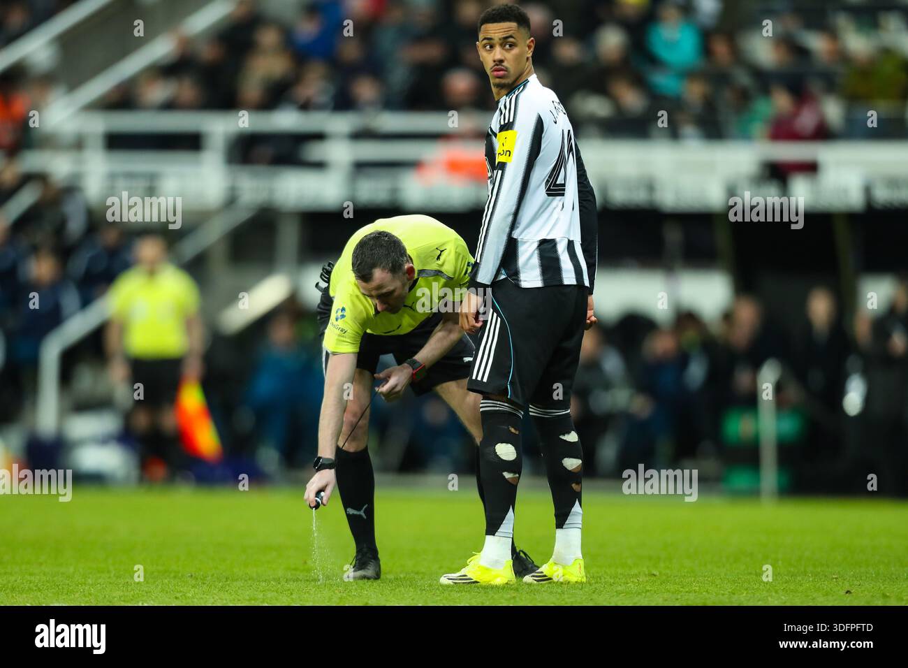 Referee Chris Kavanagh sprays foam on the ground during the Newcastle ...