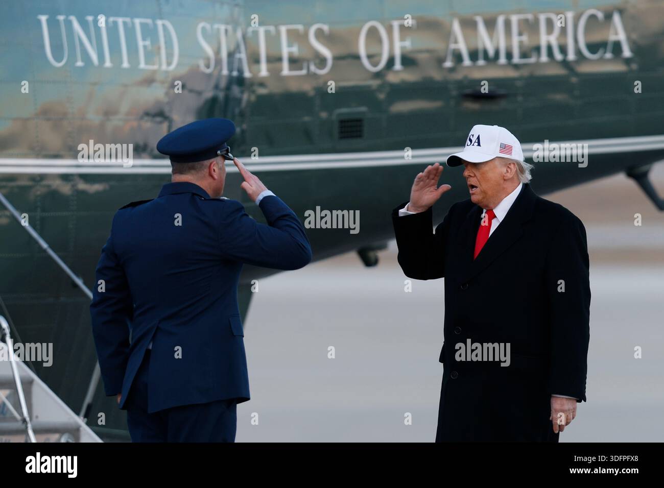 President Donald Trump, right, salutes Air Force Col. Christopher M ...