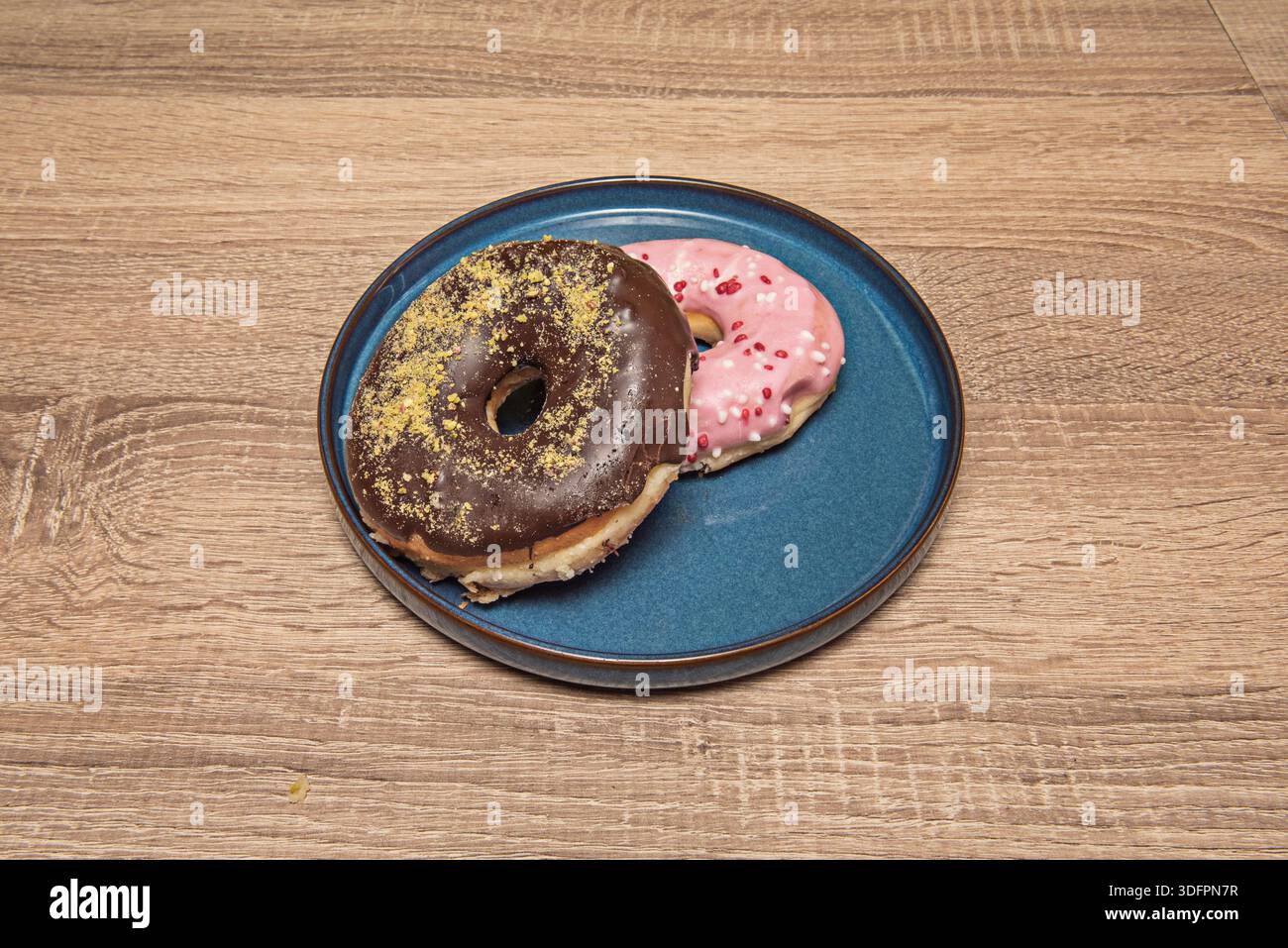 A sequence of images showing the moment a still-warm donut is dipped ...