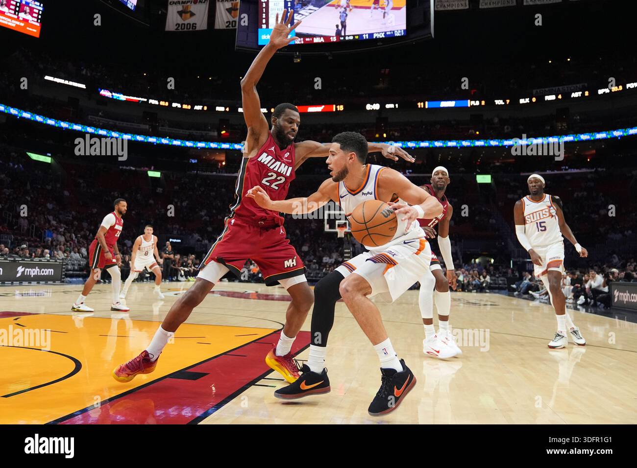 Phoenix Suns guard Devin Booker (1) drives forward defended by Miami ...