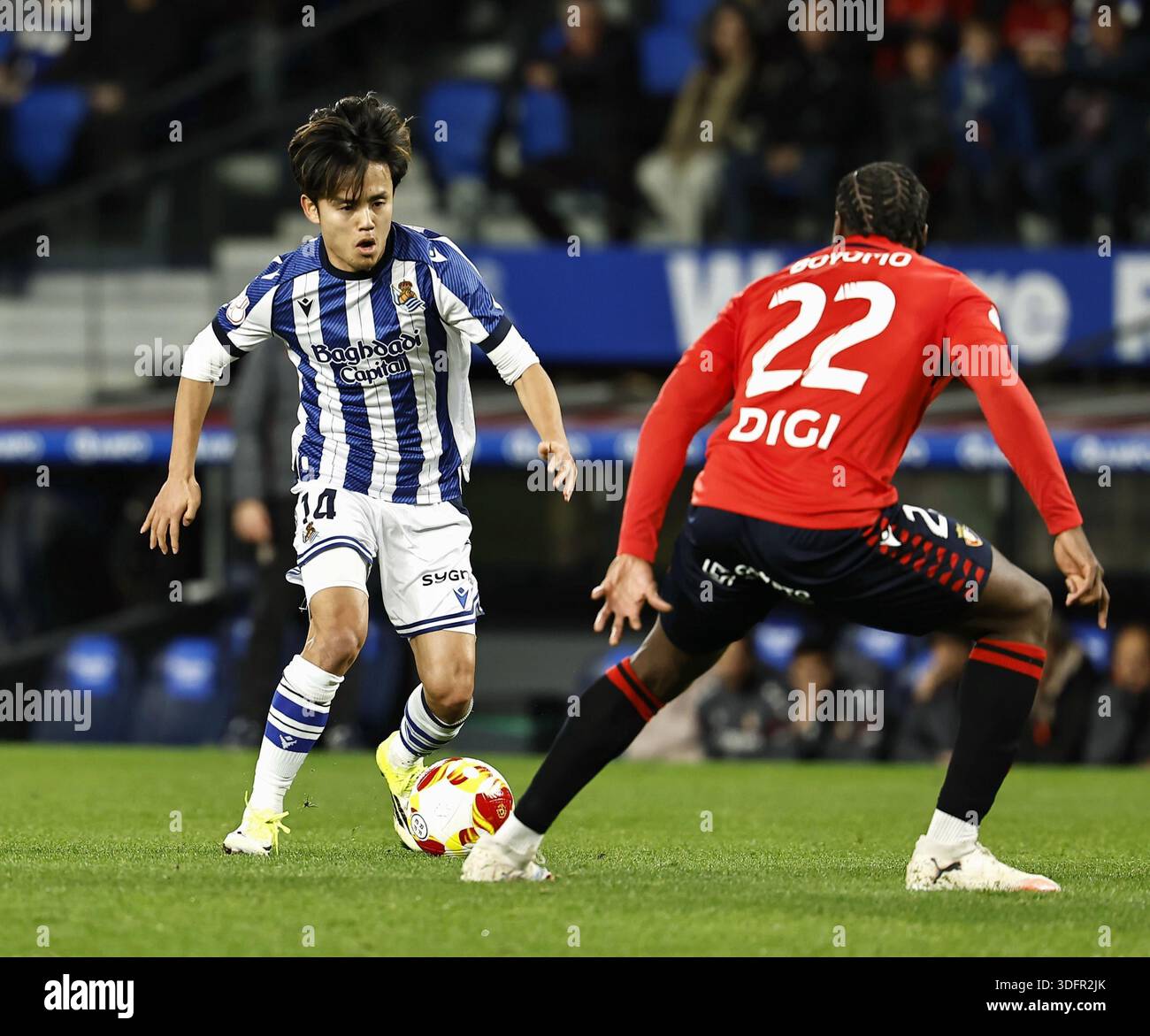 Real Sociedad's Takefusa Kubo (L) squares off against Osasuna's Enzo ...