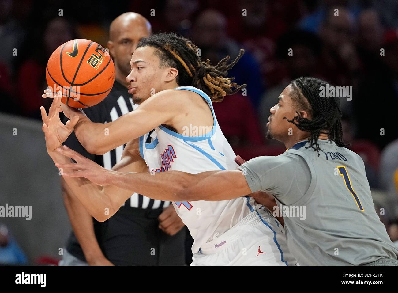 West Virginia's Jasper Floyd (1) tips the ball away from Houston's ...