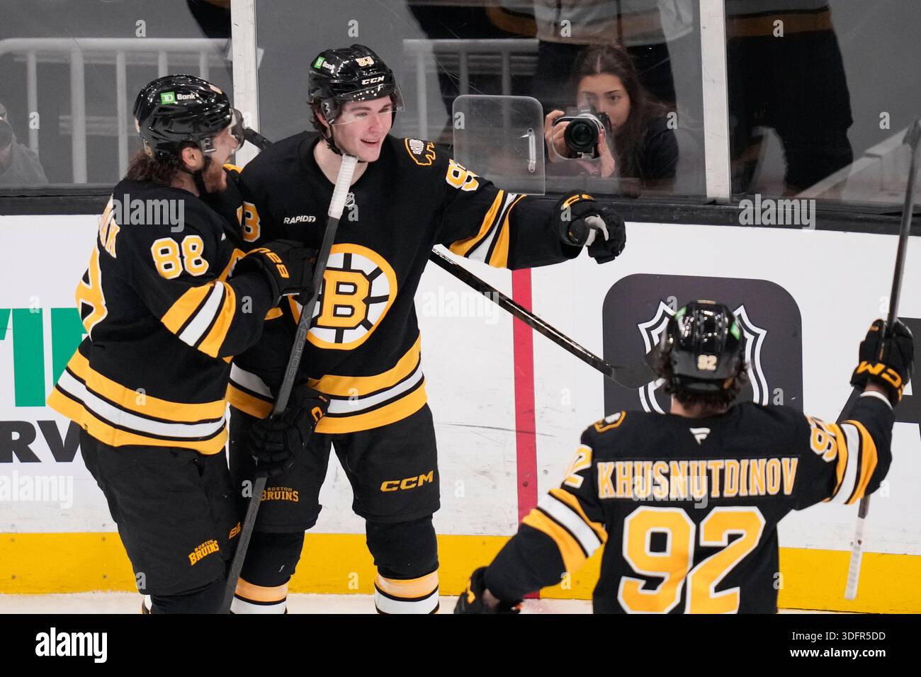 Boston Bruins center Fraser Minten, center, is congratulated after his ...