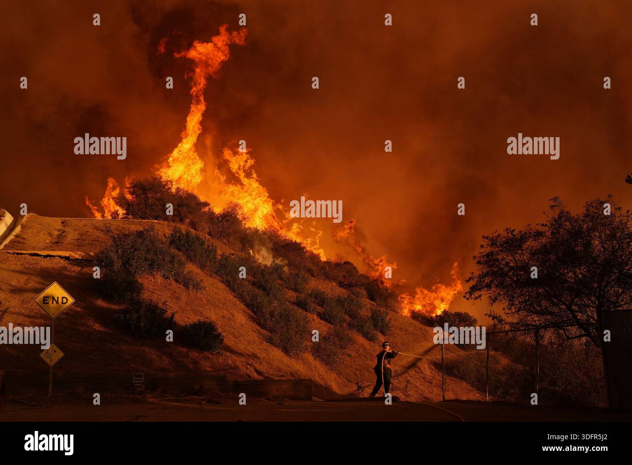 FILE - A firefighter battles the Palisades Fire in Mandeville Canyon on ...
