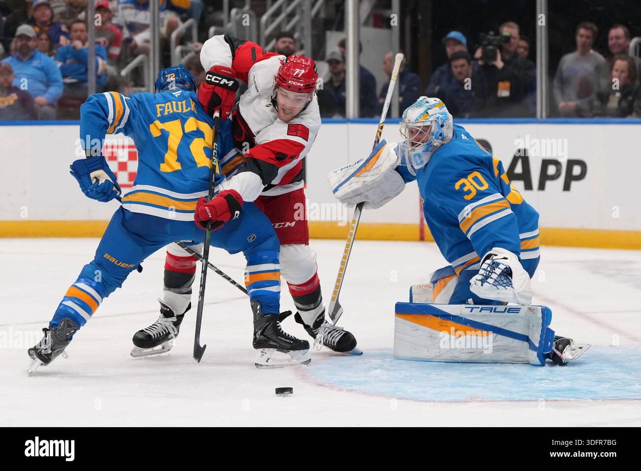 Carolina Hurricanes' Mark Jankowski (77) reaches for the puck between ...