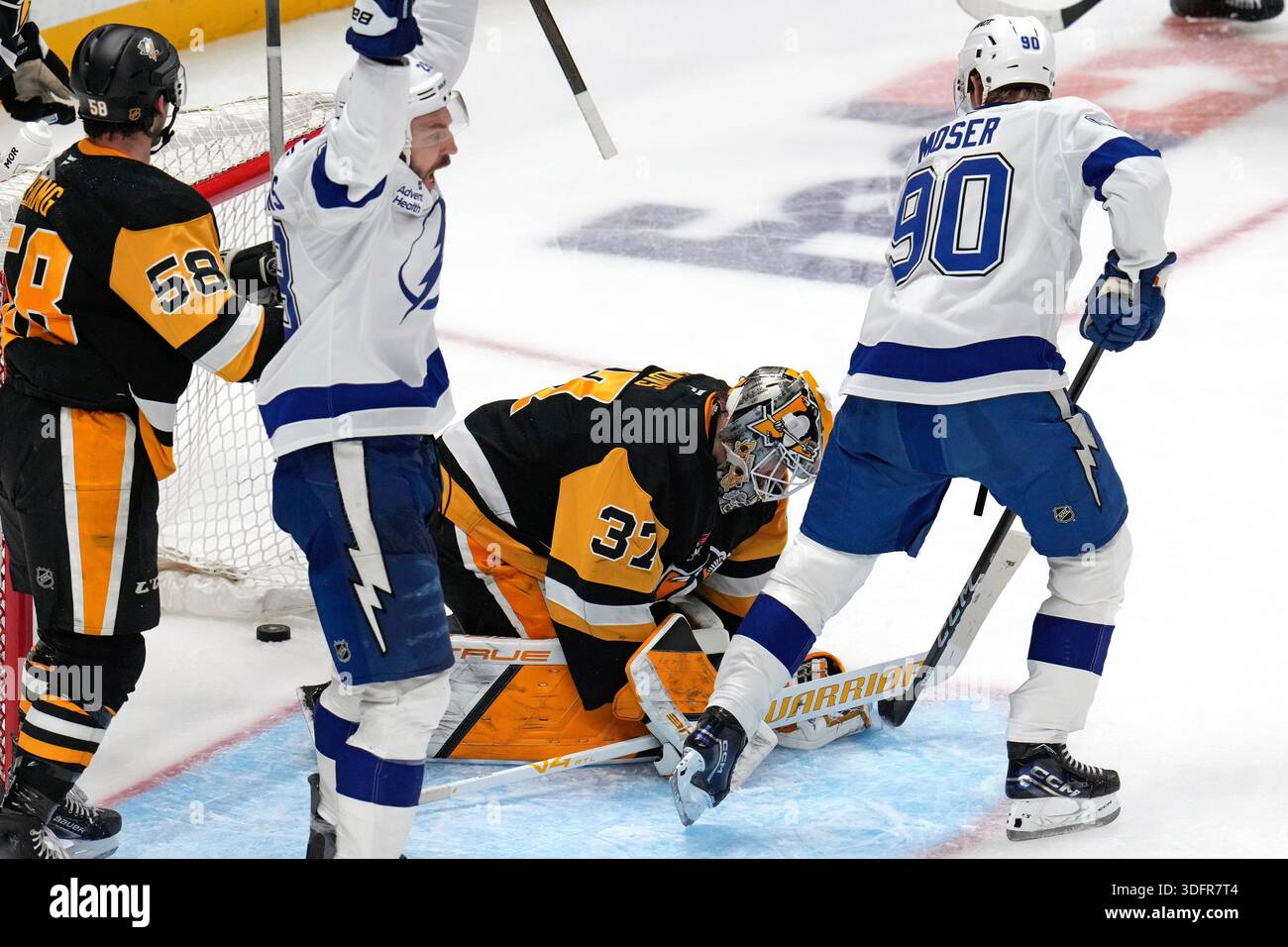 Tampa Bay Lightning's J.J. Moser (90) gets a rebound between the pads ...